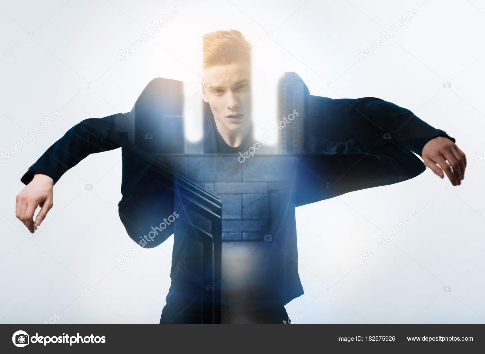 Serious young man standing and holding hands up. — Stock Photo © Dmyrto ...