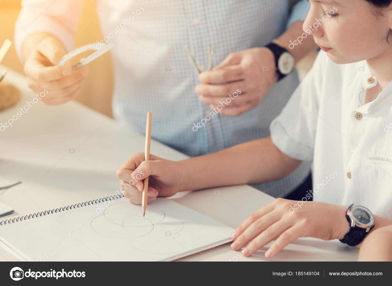 Pleasant smart boy drawing circles Stock Photo by ©Dmyrto_Z 185149104