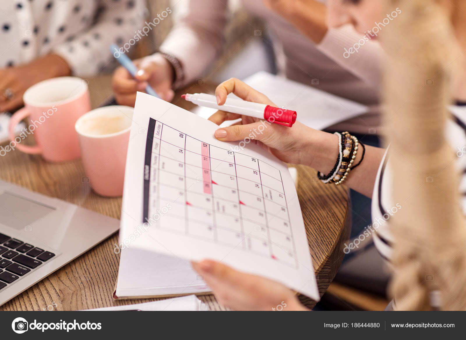 Tender female hands holding calendar — Stock Photo © Dmyrto_Z #186444880
