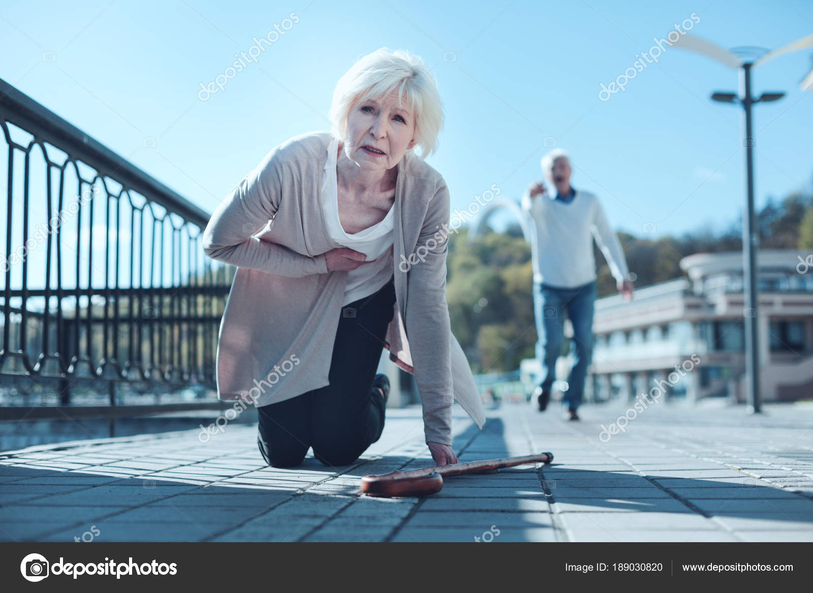 Exhausted older woman falling down with heart attack Stock Photo by ...