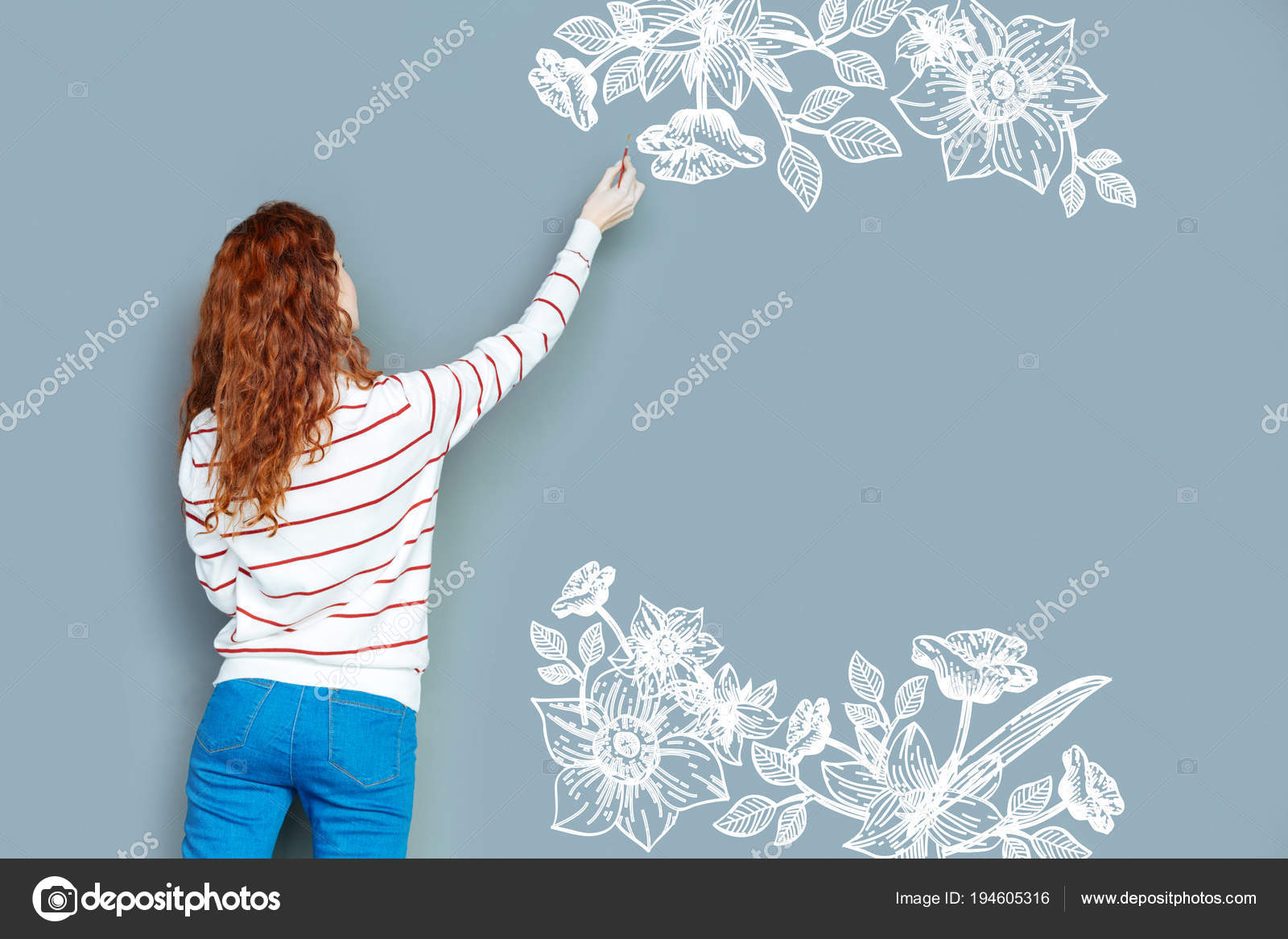 Creative designer decorating the wall and looking concentrated — Stock ...