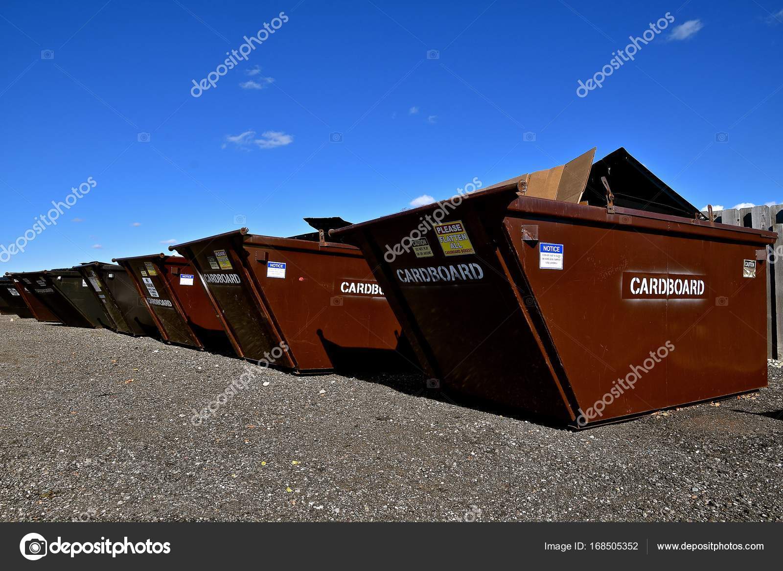 A row of dumpsters used for collecting cardboard, glass, and paper ...