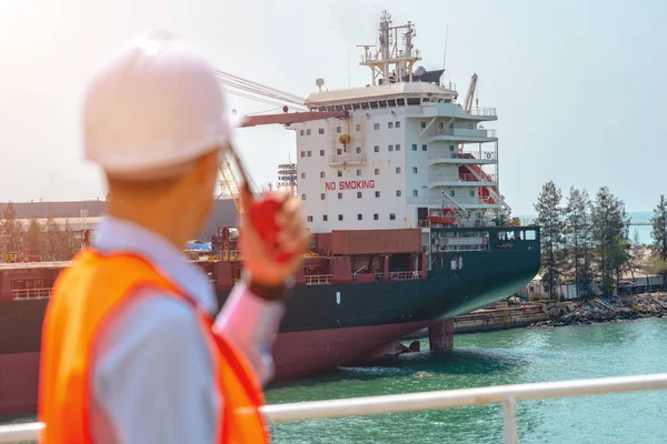 the ship under navigating by pilot and port control to berth in the ...