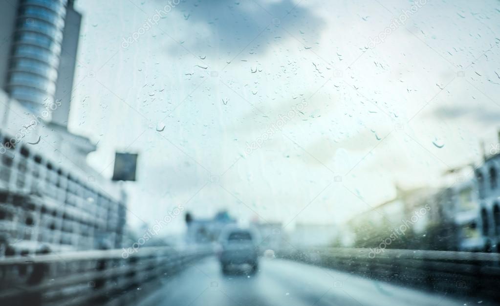 Blur background,looking through car window at raining day on roa Stock ...