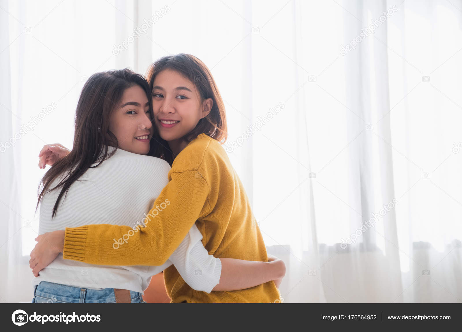 Asia Lesbian Lgbt Couple Hug And Sitting On Bed Near White Windo Stock