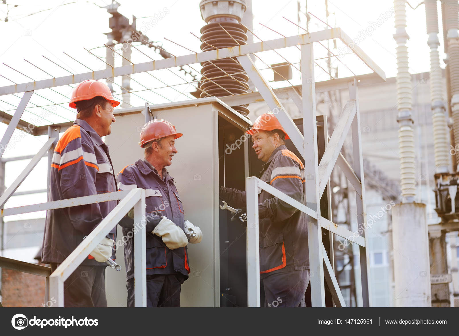 Workers repairing power transformer Stock Photo by ©Kalinovskiy 147125961