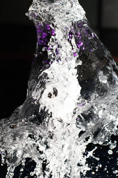 Water splash from curtain in the air over black background, Shooting ...