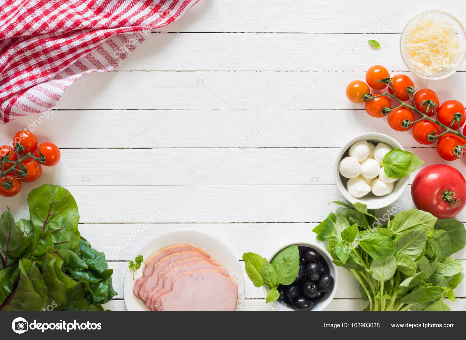 Fresh italian food cooking ingredients and textile on white wooden ...