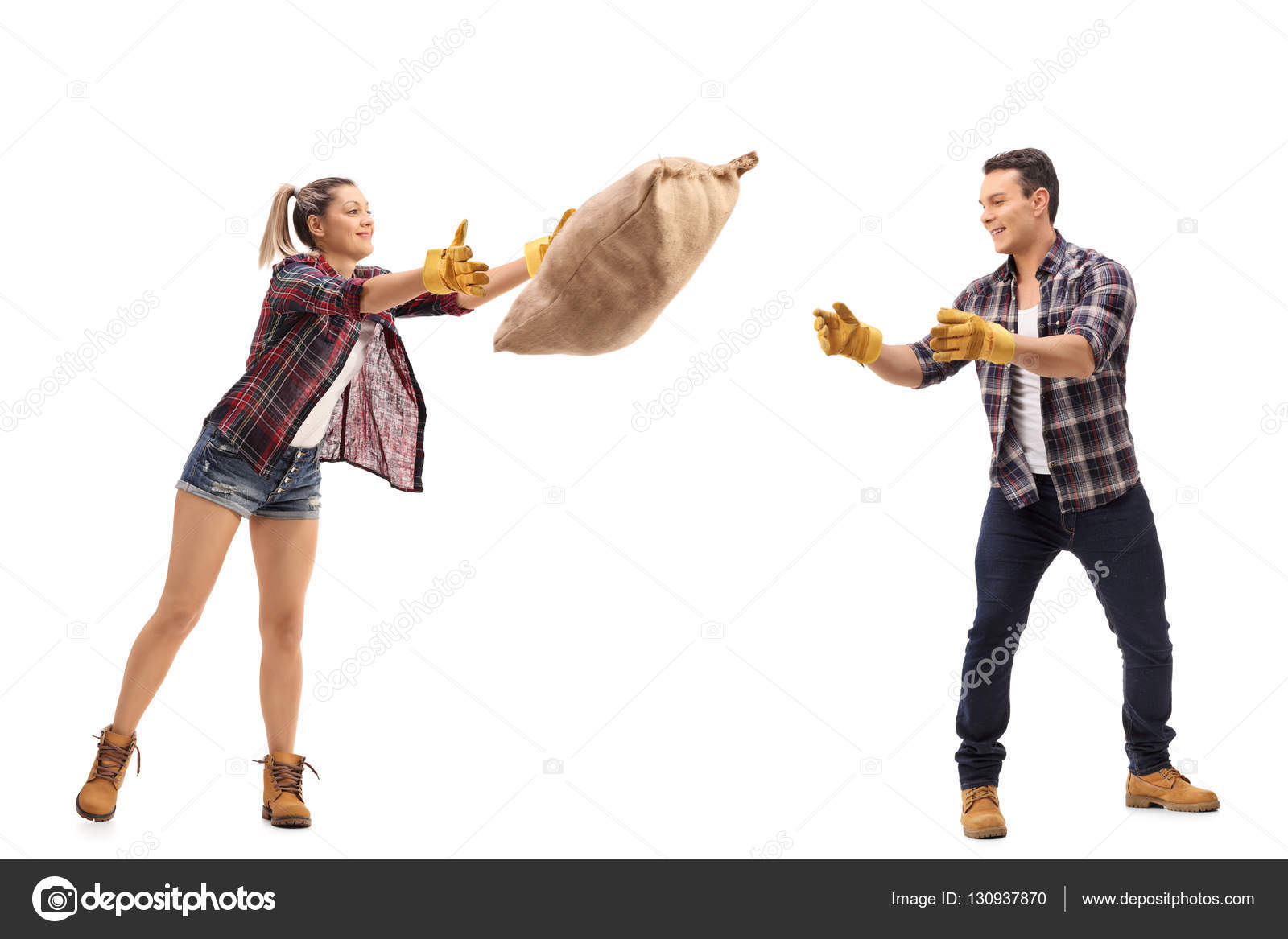 Female farmer throwing burlap sack at male farmer Stock Photo by ...