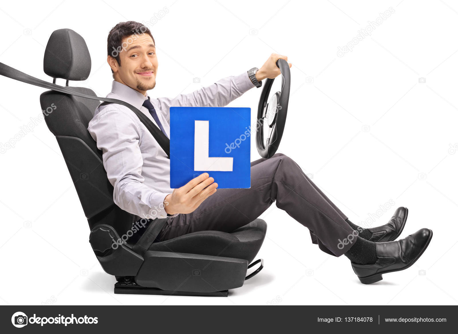 Guy sitting on a car seat and holding an L-sign — Stock Photo ...