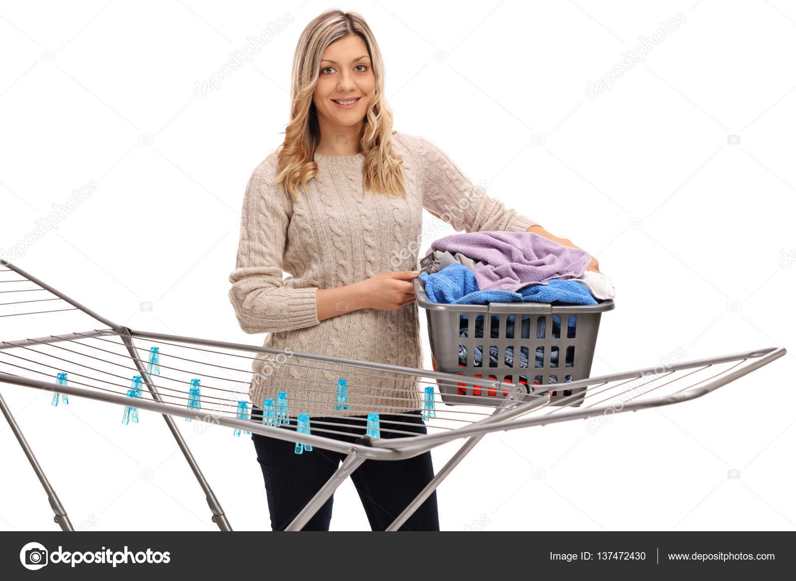 Girl holding laundry basket behind clothing rack dryer Stock Photo by ...