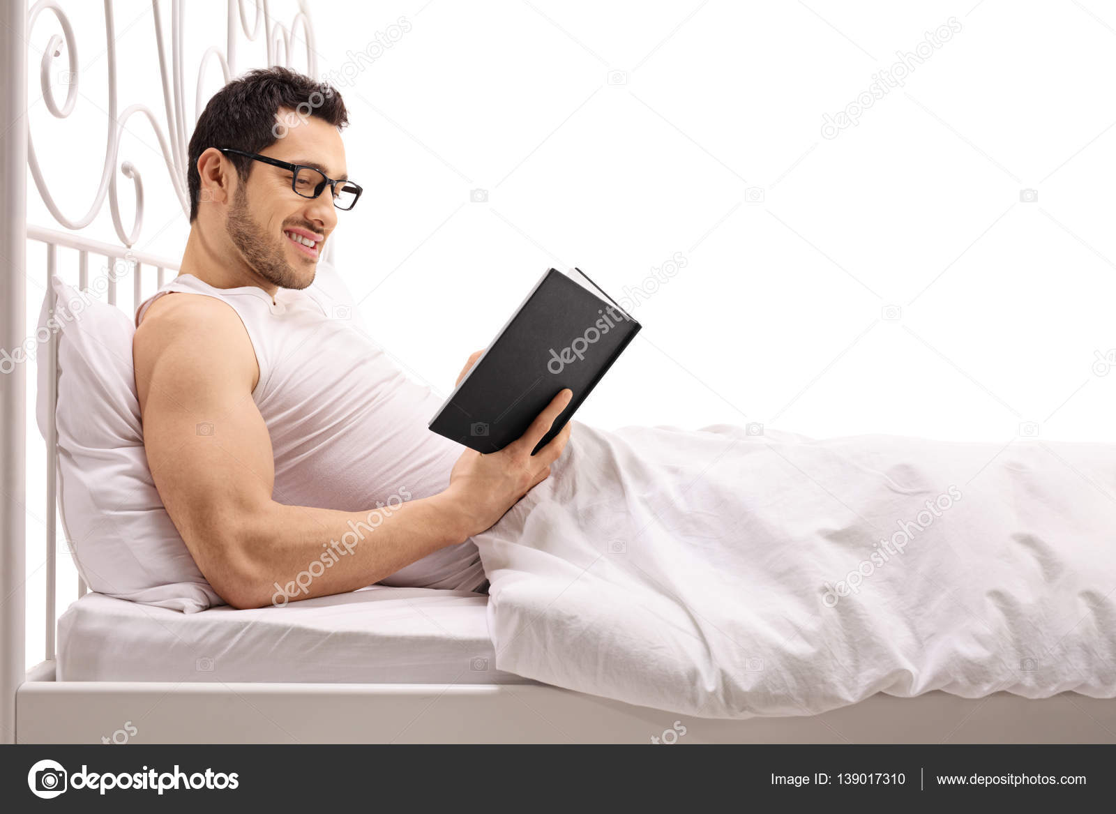 Man lying in bed and reading a book Stock Photo by ©ljsphotography ...