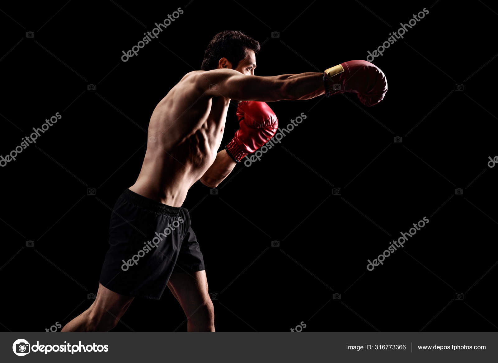 Muscular man punching with boxing gloves Stock Photo by ©ljsphotography ...