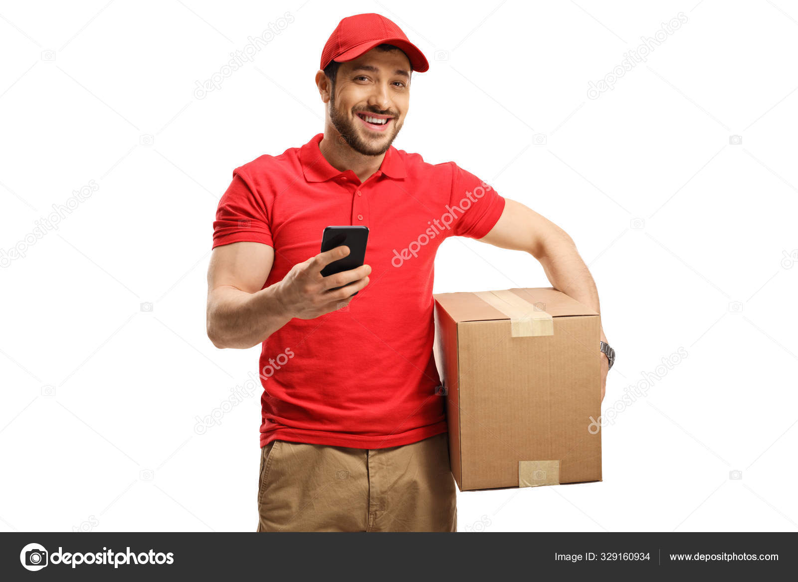 Delivery guy holding a box and a mobile phone and smiling at the Stock ...