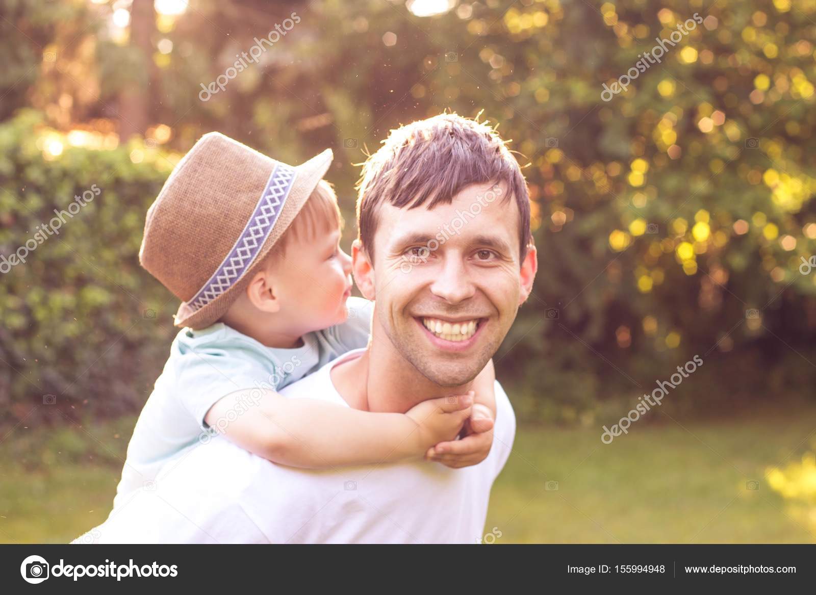 Father And Son Walk At Sunset Happy Dad And Young Son In The Sun