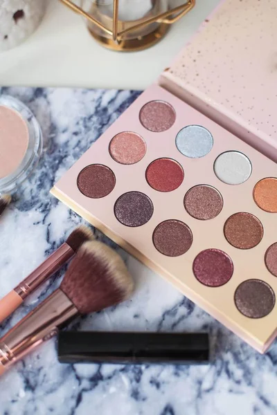 Cosmetics. Makeup. Dressing table. Home decor. Candle, eyeshadow ...