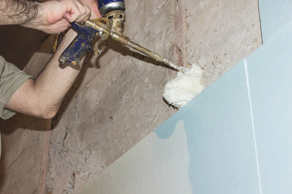 Filling the hole in the wall construction foam - Stock Image - Everypixel