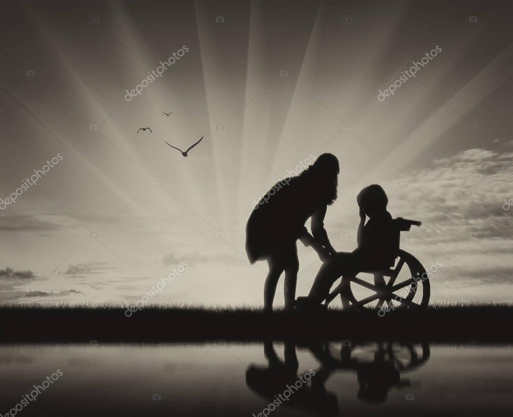 Disabled child in wheelchair crying and his mother on beach and ...