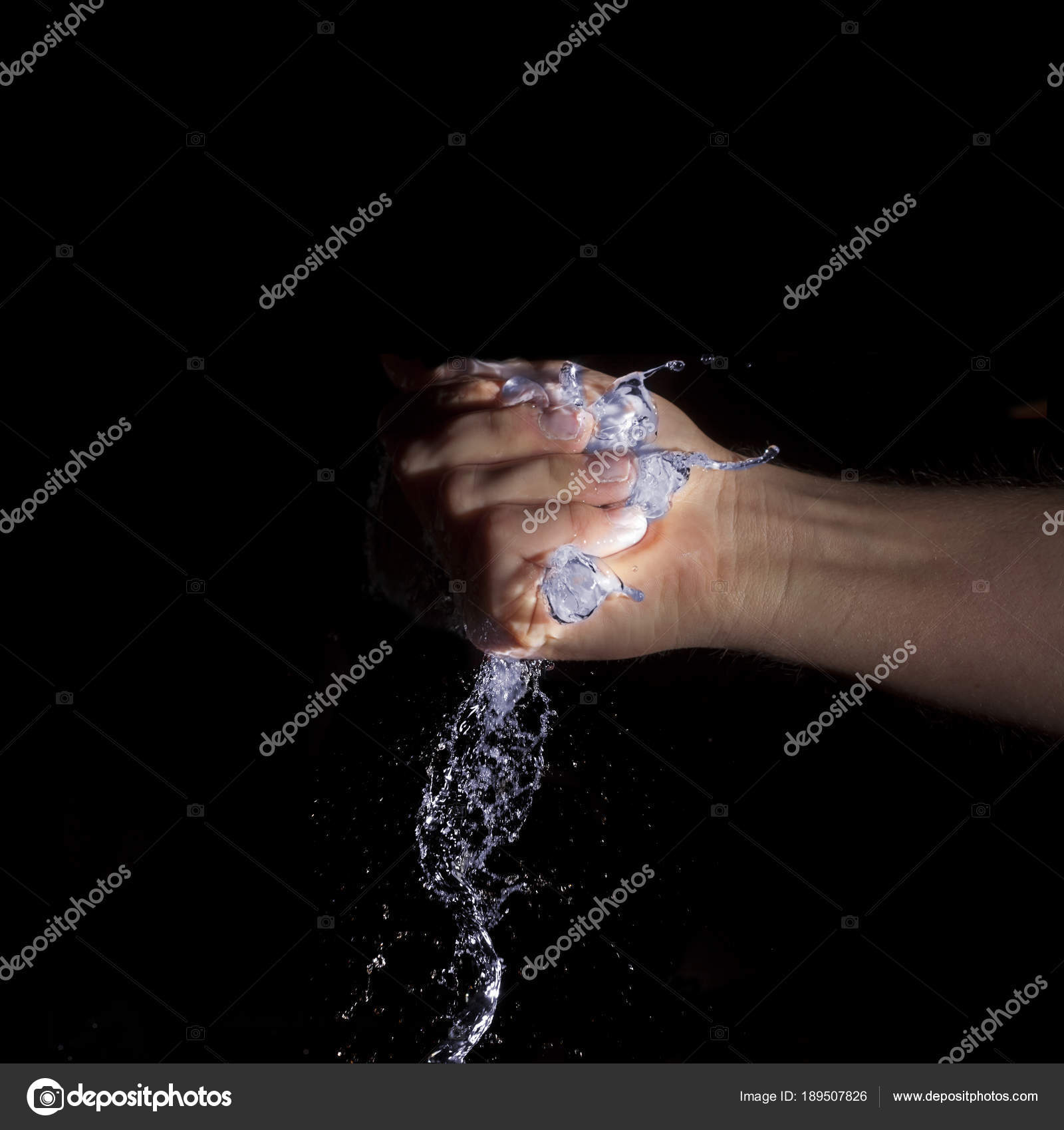 Hand holding blue glowing water on black background Stock Photo by ...