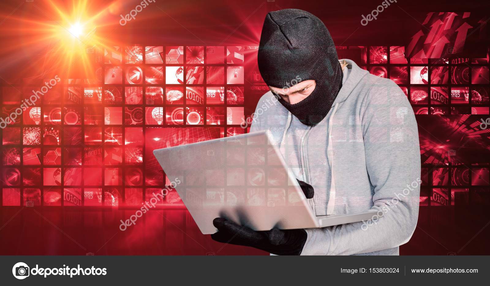 Hacker wearing monkey cap while using laptop Stock Photo by ...