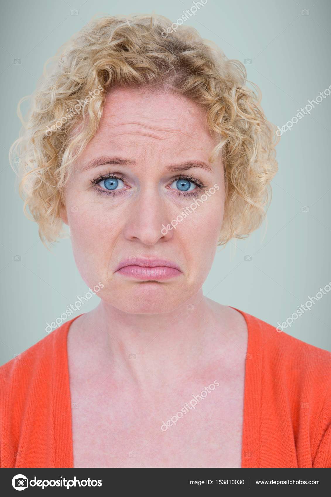 Woman pouting against light blue background Stock Photo by ...