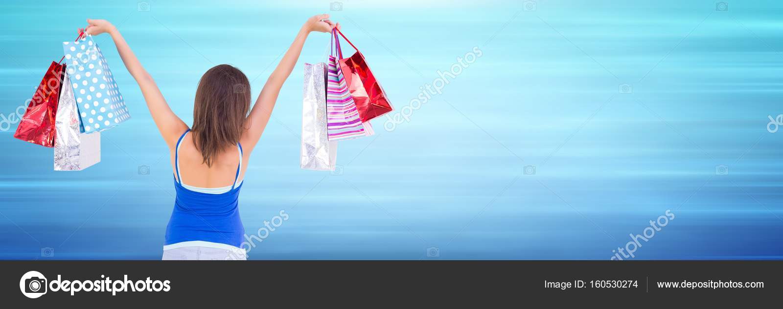 Back of shopper with bags in air against blurry blue background — Stock ...