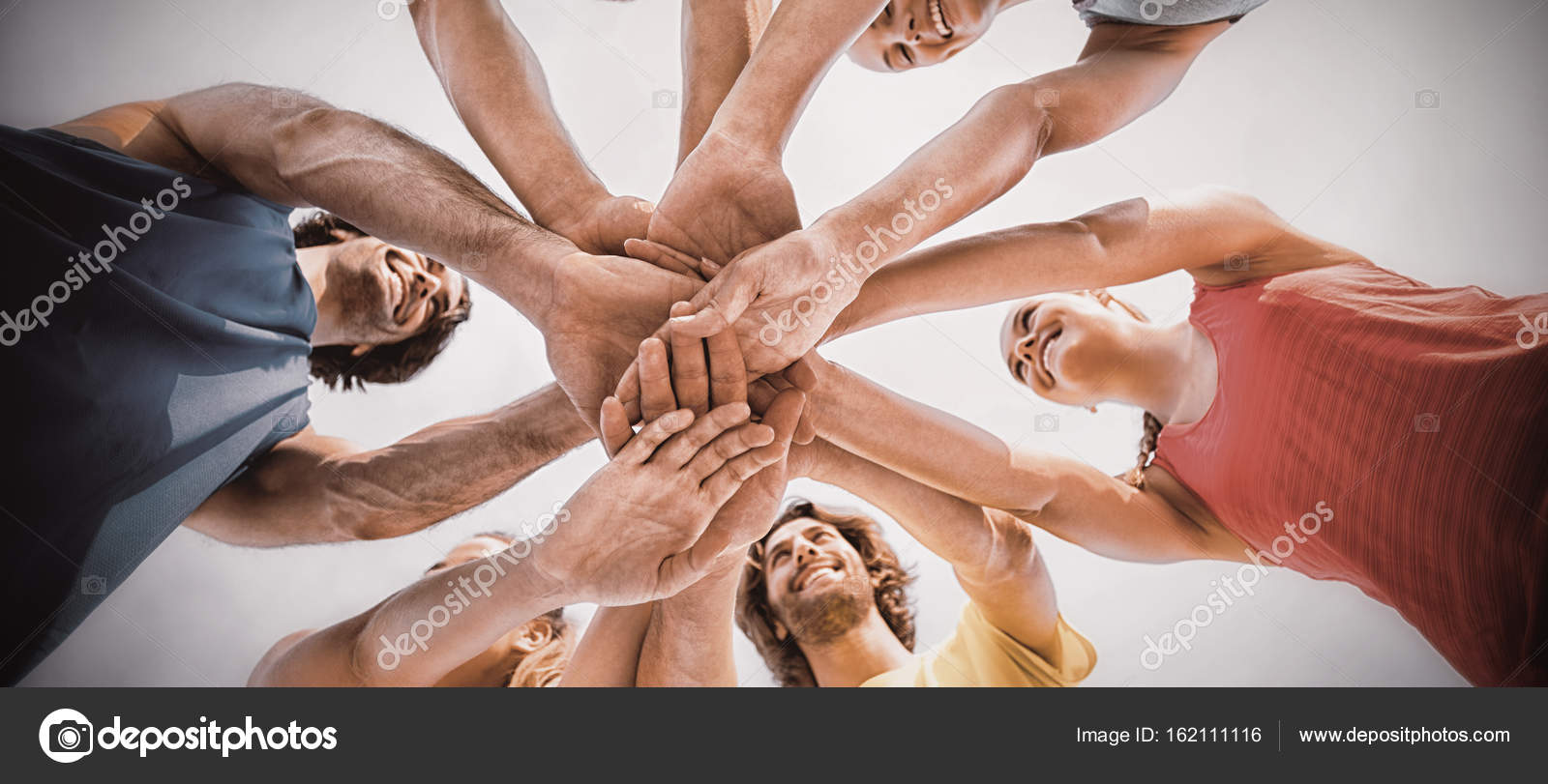 Friends standing with stacked hands Stock Photo by ©vectorfusionart ...
