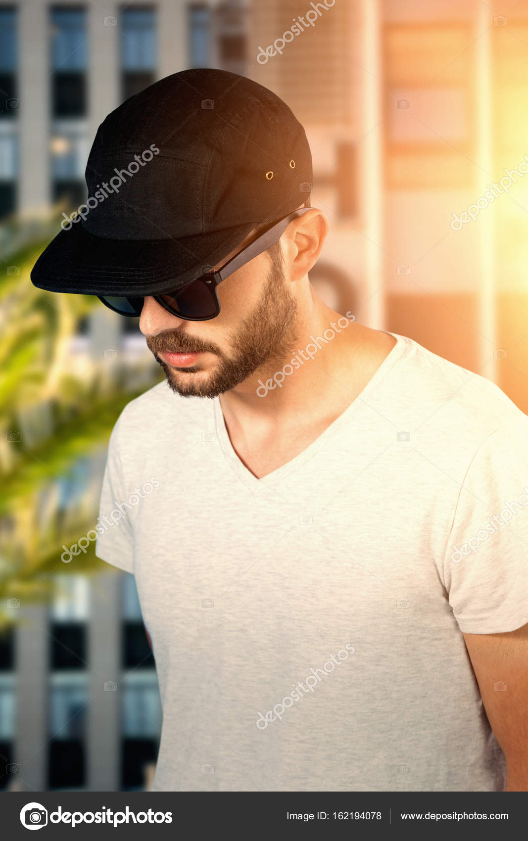 Male model wearing black cap and sunglasses Stock Photo by ...