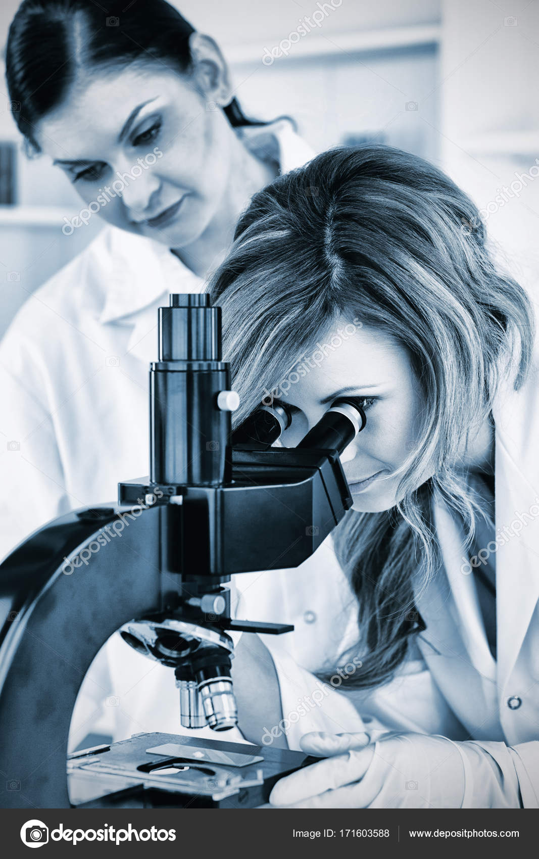 Scientist looking through a microscope Stock Photo by ©vectorfusionart ...