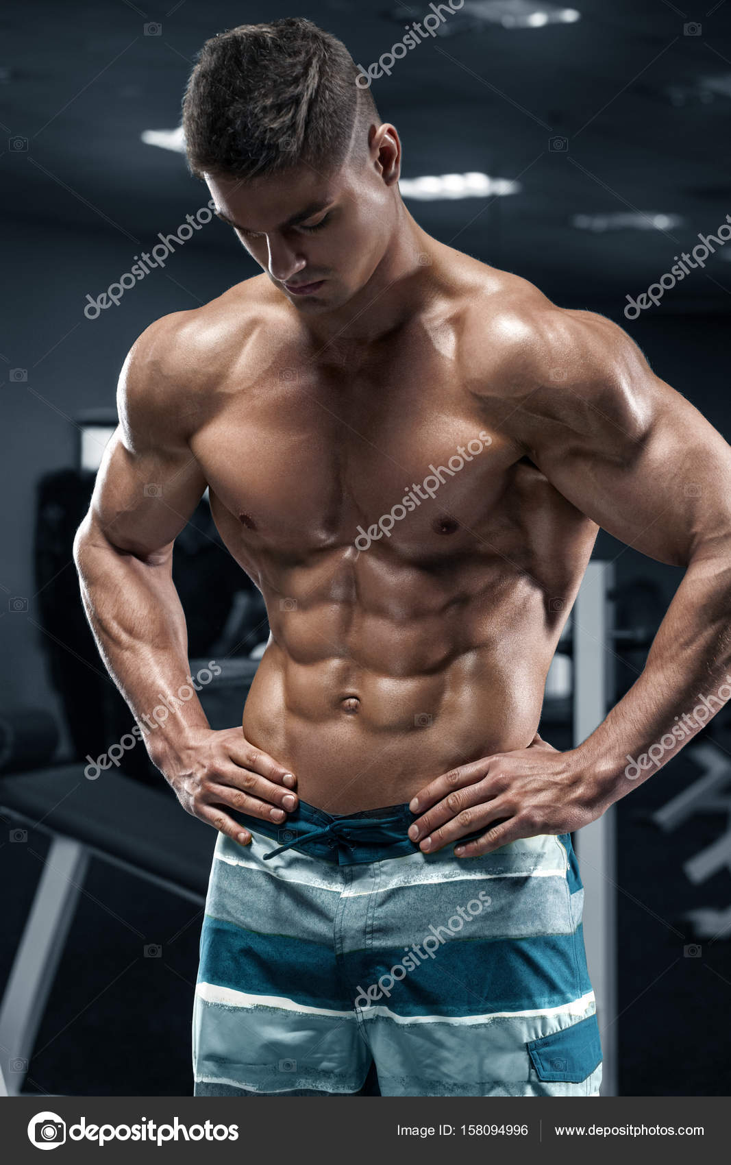 Muscular man in gym, abs, working out. Strong male naked torso, shaped ...