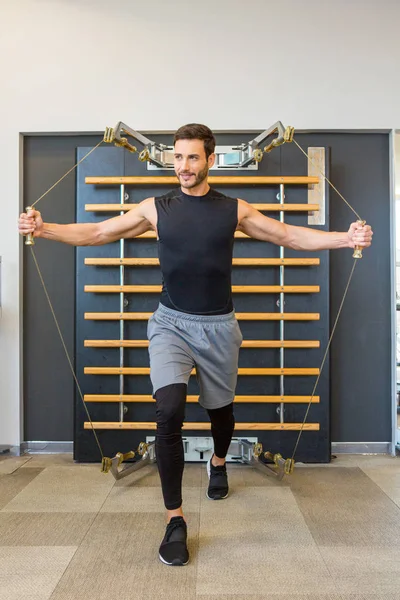 Full body cable pulley machine workout in the gym Stock Photo by ...