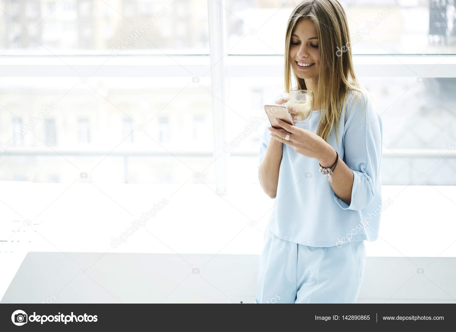 Happy girl reading feedback from followers via modern touchpad ...