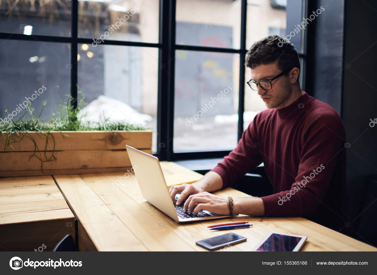 Young concentrated male copywriter Stock Photo by ©GaudiLab 155365166