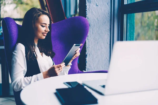 Charming female director reading financial news on website using ...