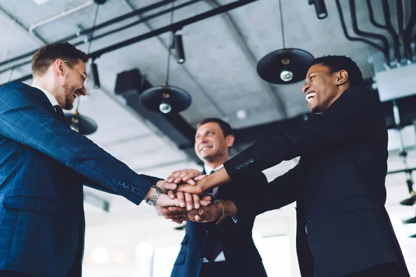 Happy laughing positive successful multiethnic male managers putting ...