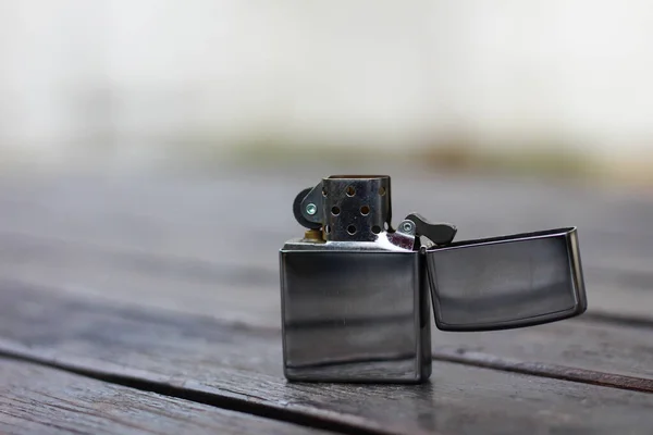Lighter on an old wooden table, background - Stock Image - Everypixel