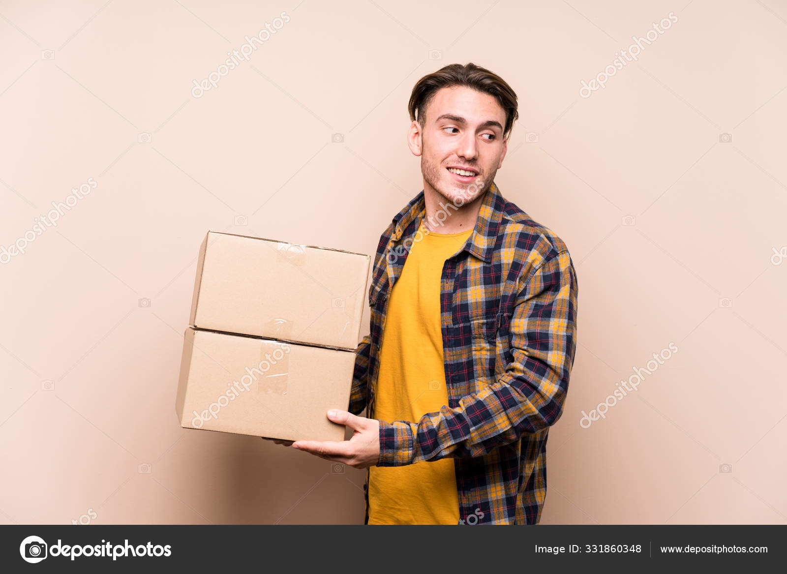 Young Caucasian Man Holding Boxes Looks Aside Smiling Cheerful Pleasant ...