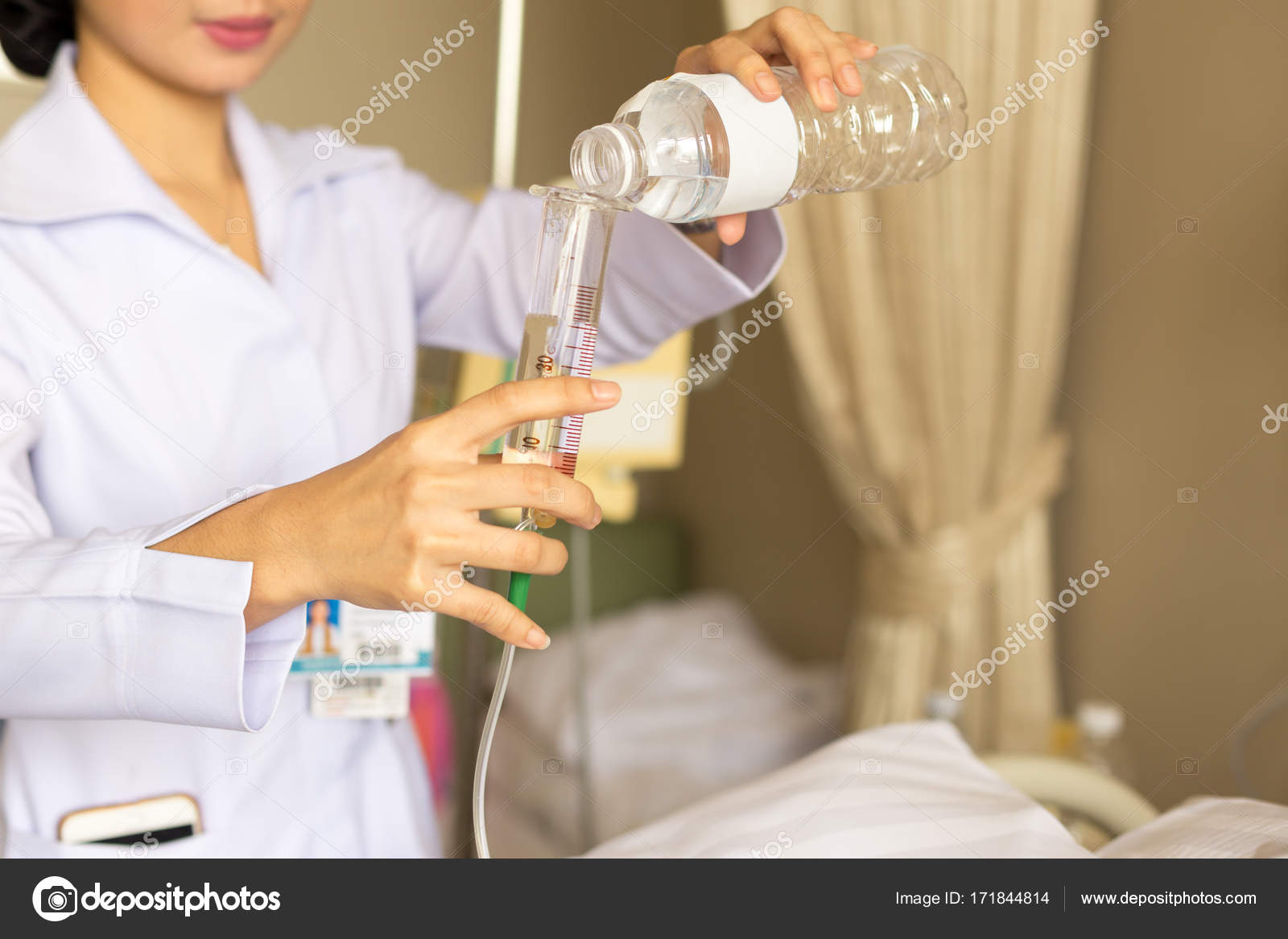 Nurse giving patient water using glass syringe to irrigate nasog ...