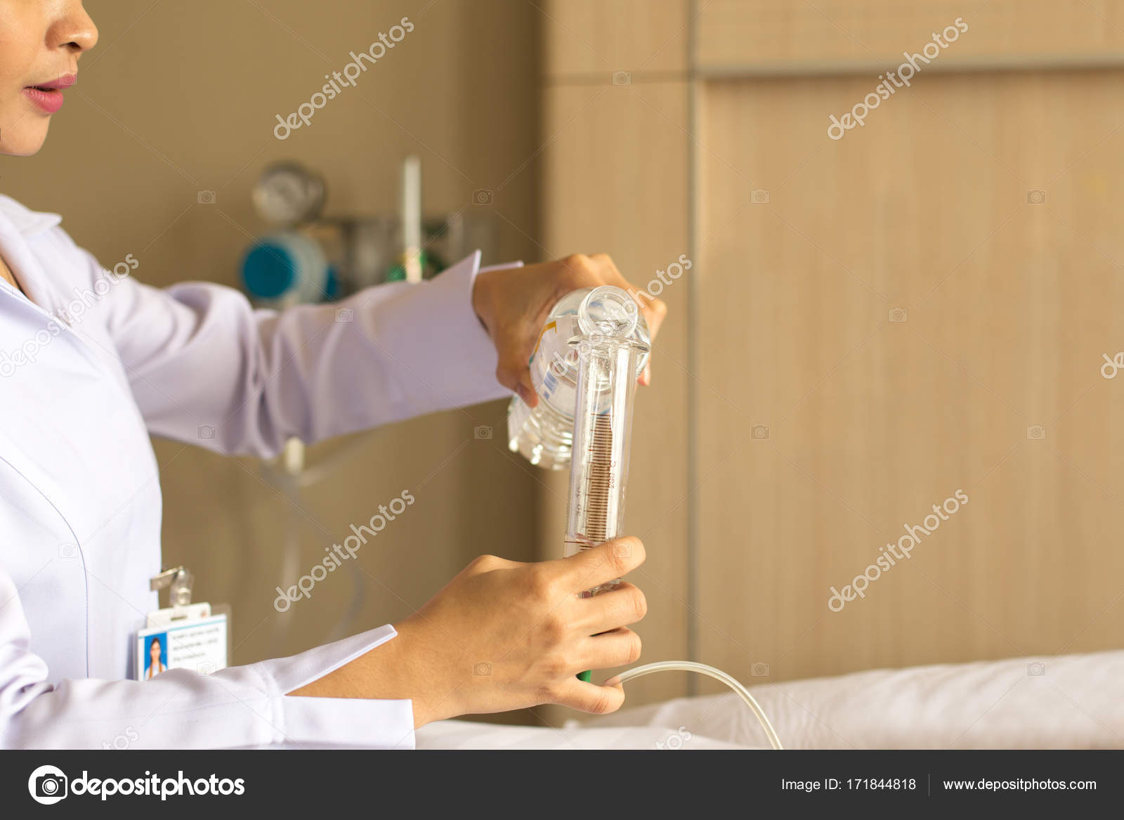 Nurse giving patient water using glass syringe to irrigate nasog Stock ...