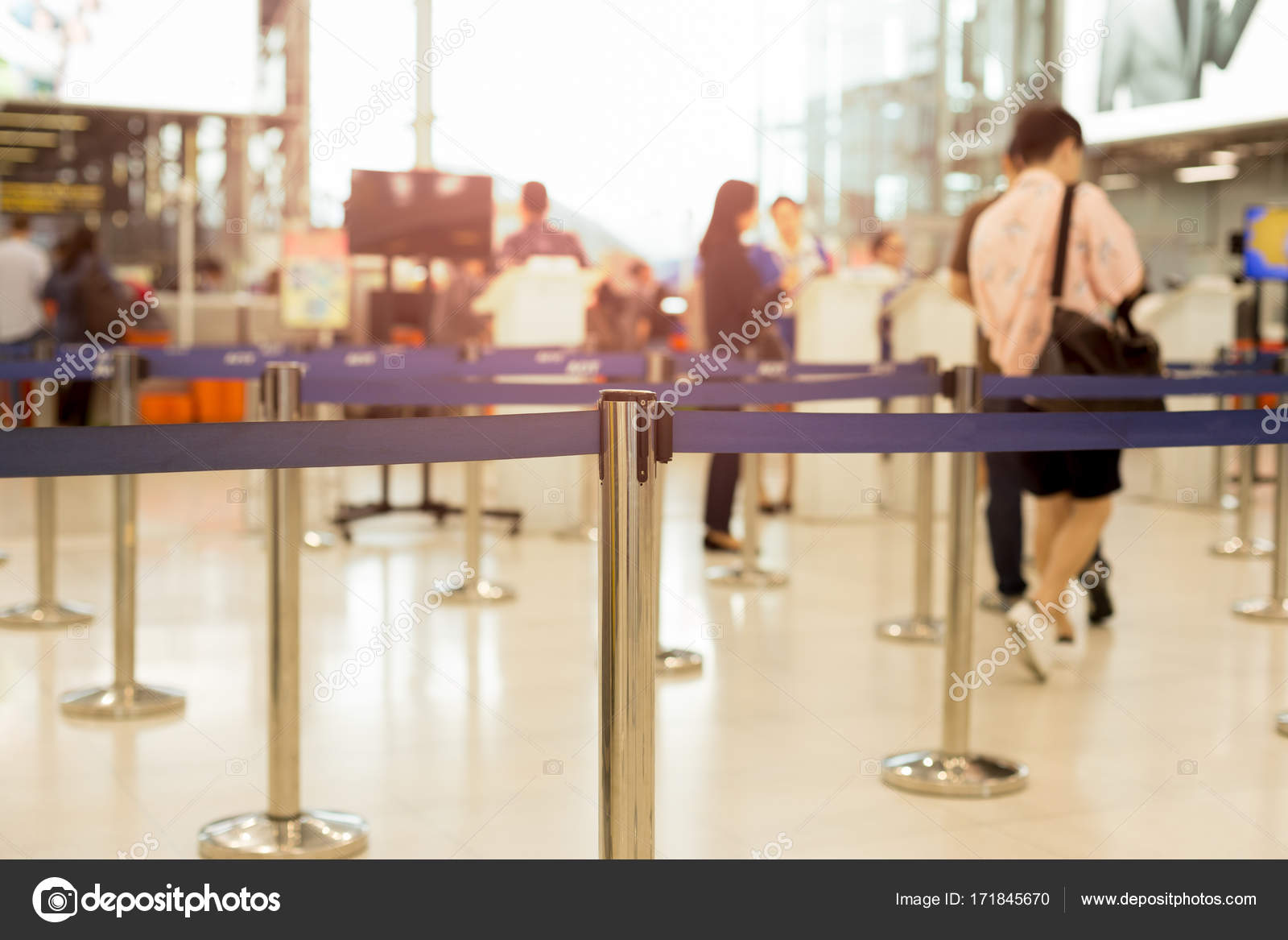 Passengers walking through check-in line at the airport Stock Photo by ...