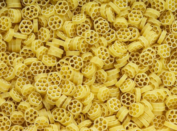 Macaroni ruote pasta in glass bowl on white isolated background, in the ...