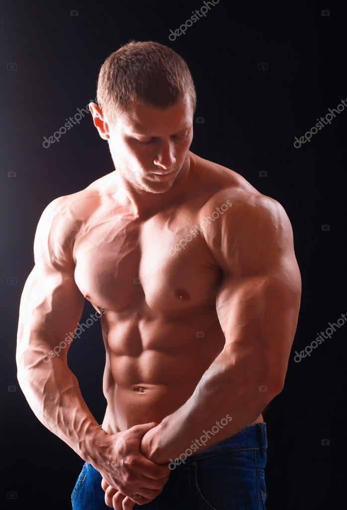 Healthy muscular young man. Isolated on black background — Stock Photo ...