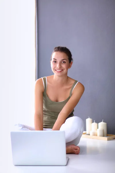 Attractive Caucasian Girl Sitting On Floor With Cup And Tablet Near