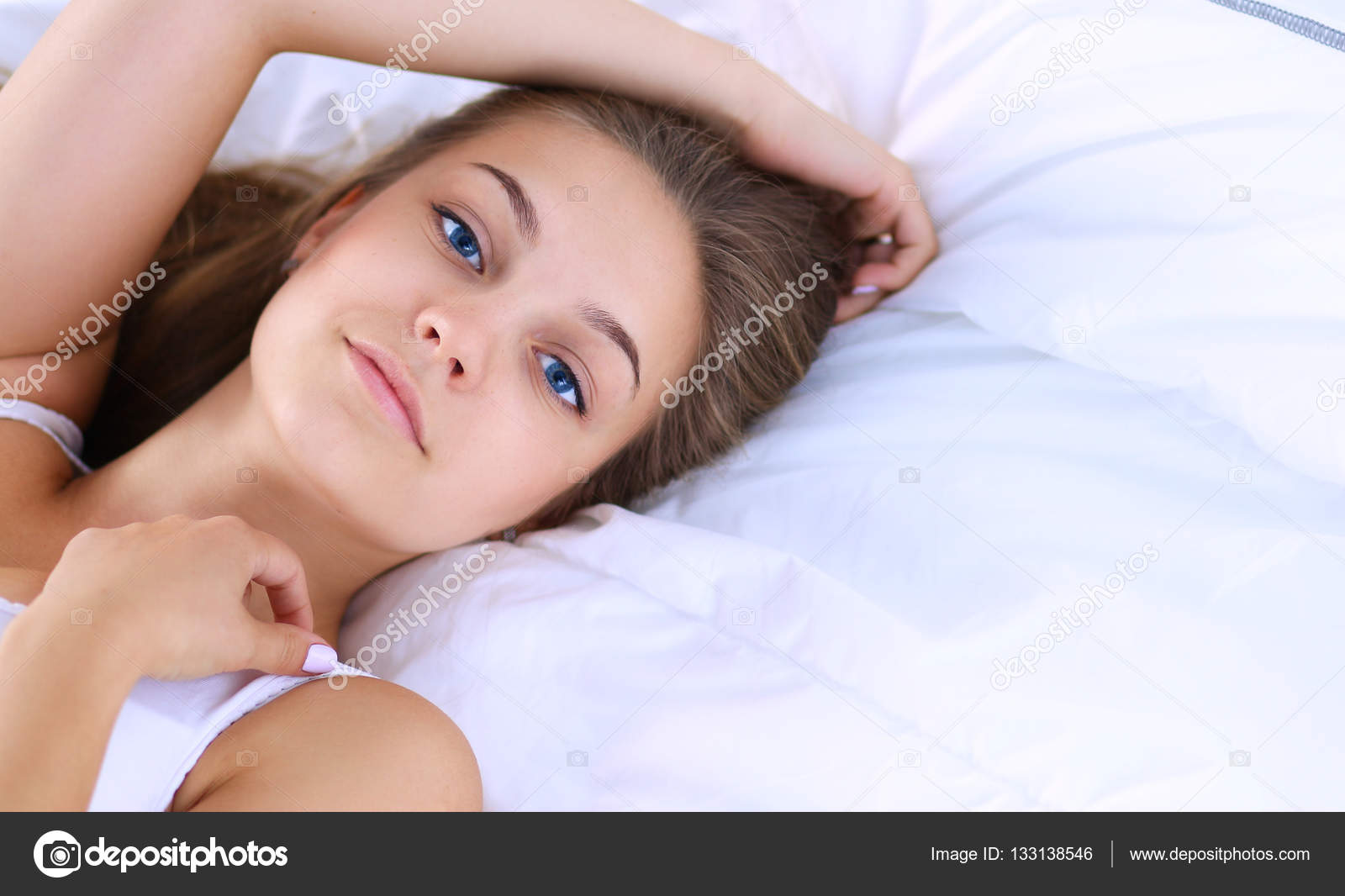 A Beautiful Young Woman Lying In Bed Comfortably And Blissfully Stock