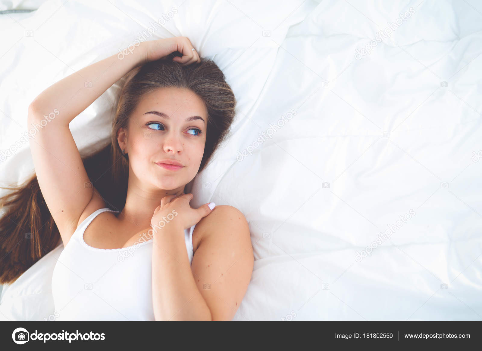 A Beautiful Young Woman Lying In Bed Comfortably And Blissfully Stock