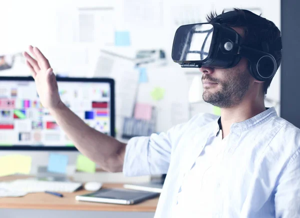 Young male software programmer testing a new app with 3d virtual ...