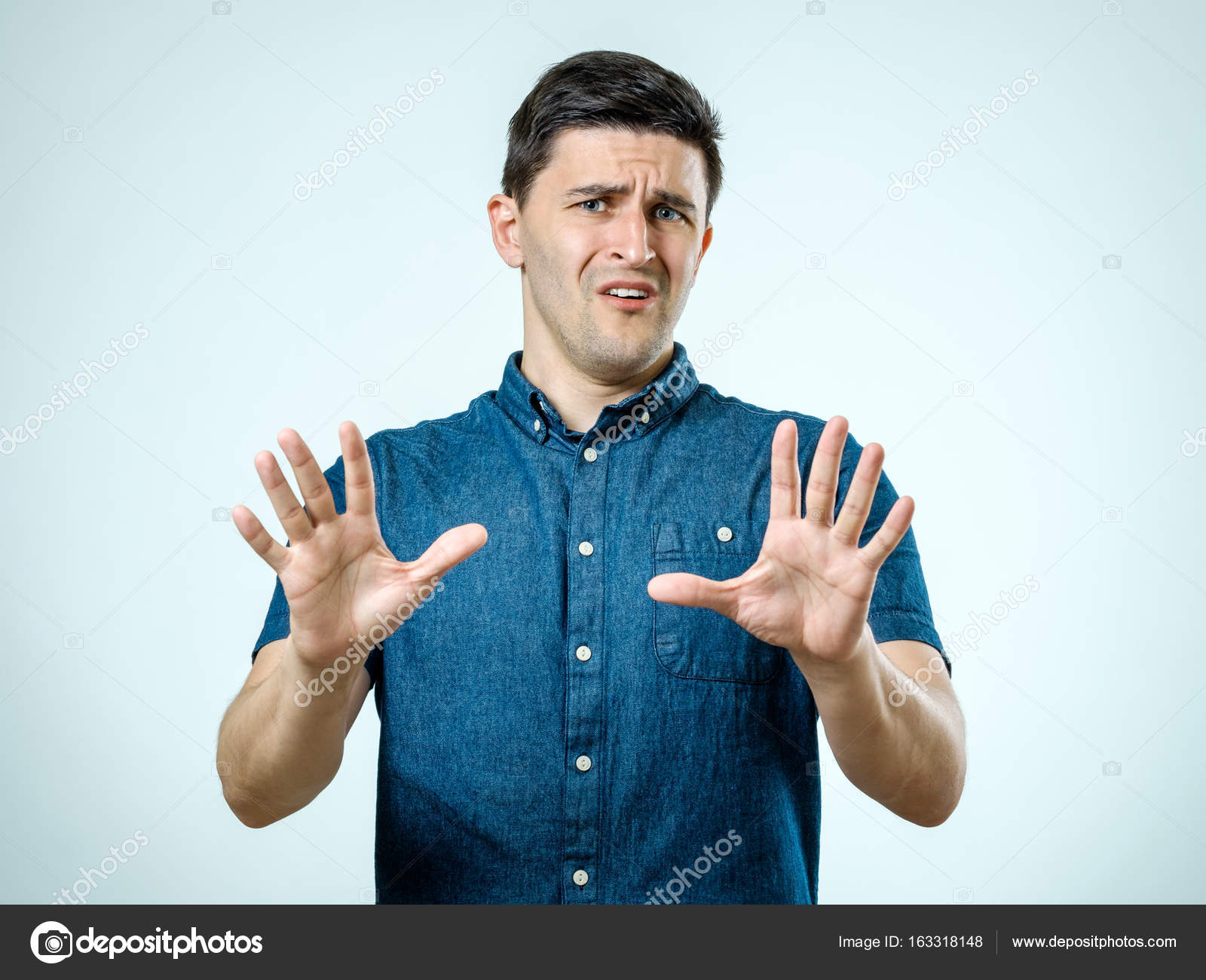 Man with scared expression on his face making frightened gesture Stock ...