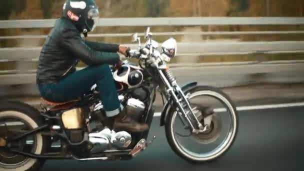 A young man riding a chopper on a road — Stock Video © aeroegor #185780122
