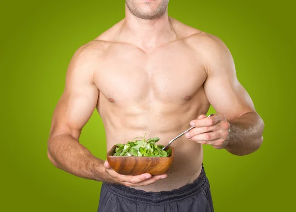 Muscular man eating healthy food — Stock Photo © aallm #58918045