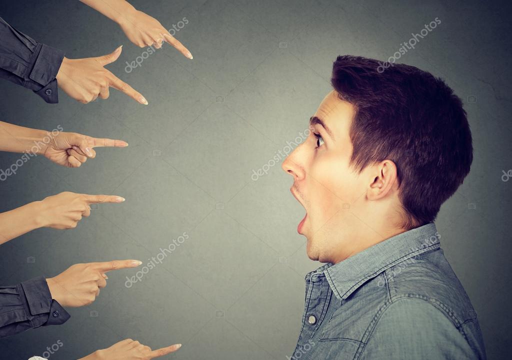 Shocked man looking at many fingers pointing at him Stock Photo by ...